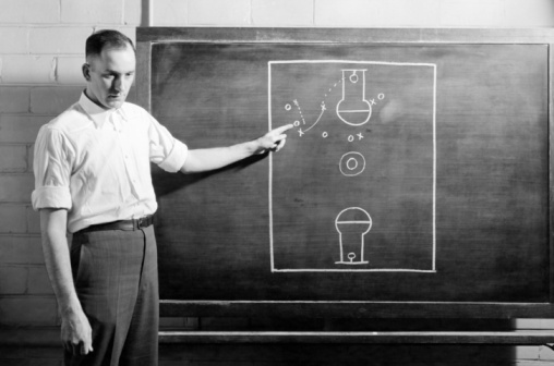 coach-pointing-blackboard | Hoops U. Basketball